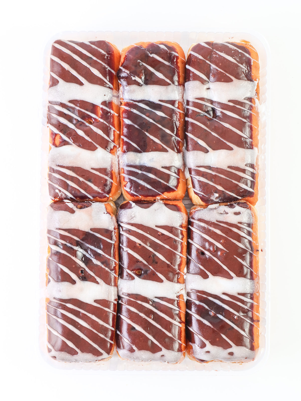 Chocolate Iced Custard Filled Long John with White Drizzle | Prairie ...